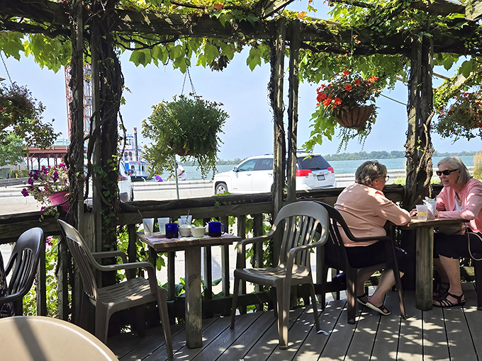 The vine-covered patio offers waterfront views that turn lunch into an occasion worth dressing up for.