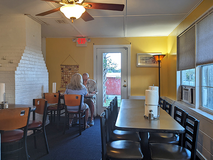 The yellow-walled dining area offers a sunny backdrop for serious eating. These diners know they've found a place where the food matters more than the decor. 