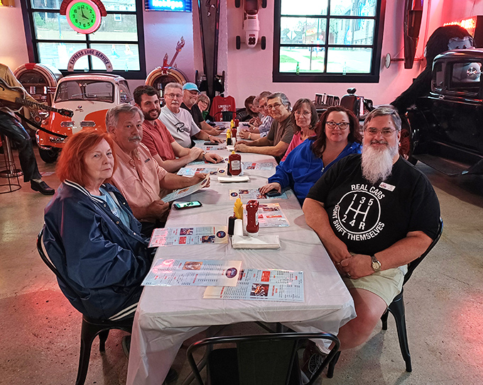 Local car enthusiasts gather around tables where horsepower talk mixes perfectly with comfort food conversations.