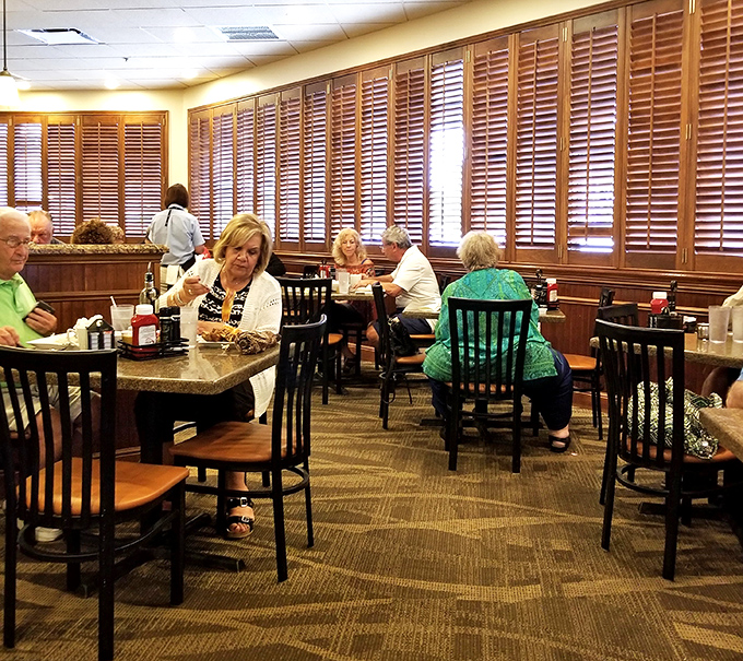 Wooden shutters filter Florida sunshine as diners engage in the serious business of enjoying a proper meal.