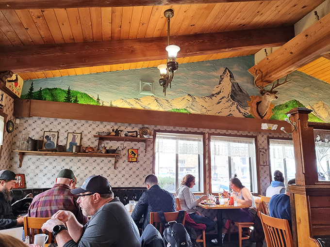 The Alpine-inspired dining room, complete with mountain mural, makes every breakfast feel like you've escaped to a Swiss chalet.