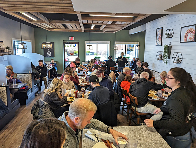 A full house at The Breakfast Club—where strangers become temporary neighbors united by the universal language of "pass the syrup" and "is that bacon I smell?"