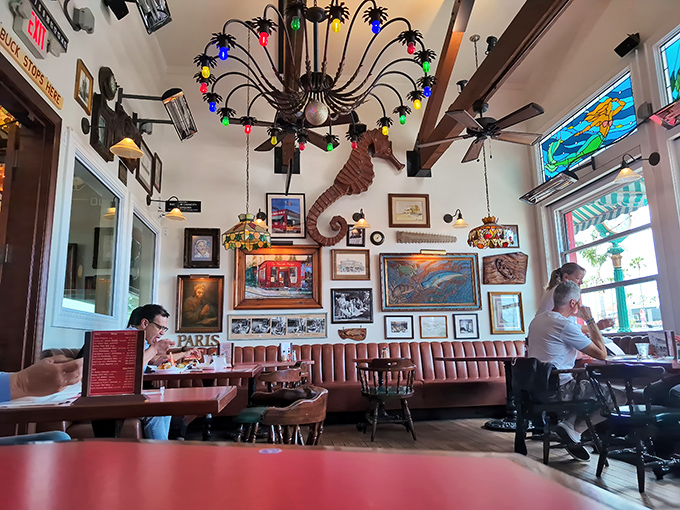 The colorful chandelier and eclectic wall art create the perfect backdrop for seafood memories. Notice the seahorse watching over diners like a maritime guardian.