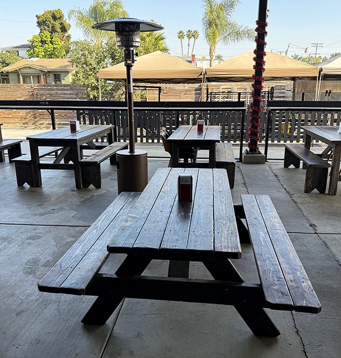 The outdoor dining area isn't just practical&mdash;it's where strangers become friends over the universal language of "pass the sauce, please."