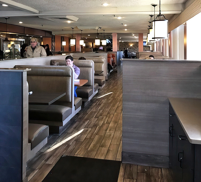 Classic booth seating arranged with mathematical precision, ensuring maximum comfort and optimal people-watching for every diner in the house.