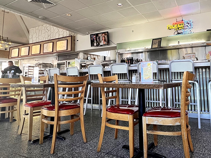 Red vinyl chairs and wooden tables set the stage for countless late-night conversations and early morning revelations.
