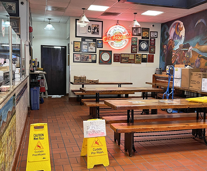 Even empty, the dining room hums with anticipation. Those neon signs and framed accolades aren't just decoration&mdash;they're trophies of taste.