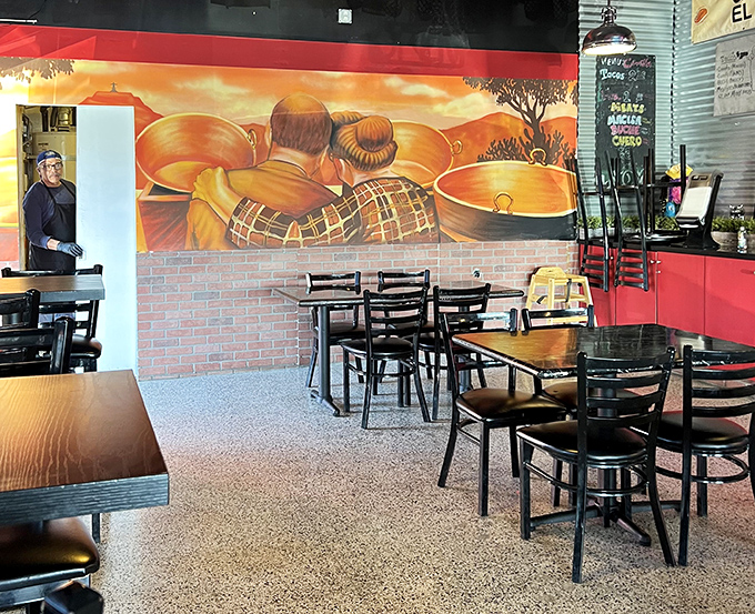 The mural tells the story: traditional copper cauldrons where carnitas magic happens, a visual reminder of the craft behind each bite.