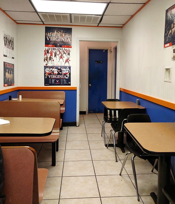 UVA pride adorns walls where Charlottesville gathers to feast. This dining area has hosted more happy moments than most five-star restaurants ever will.