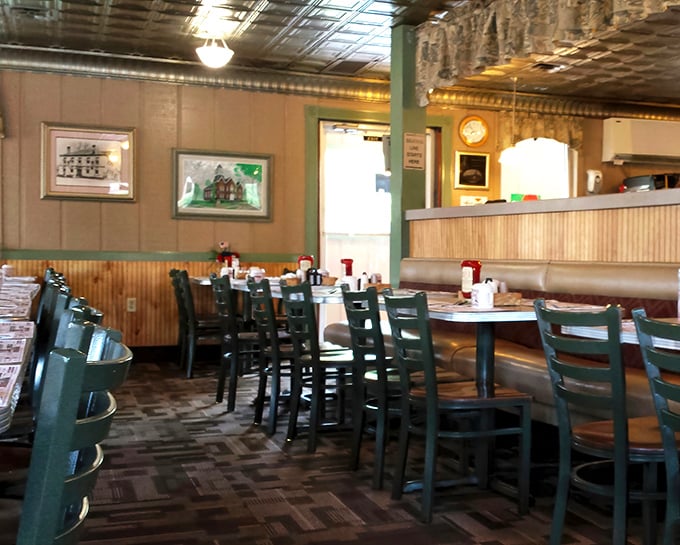 Classic green chairs and wood paneling create that timeless diner aesthetic where nothing changes because nothing needs to.
