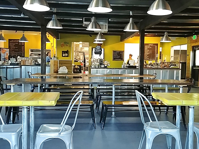 Communal tables foster breakfast friendships while exposed beams overhead create that perfect rustic-meets-modern dining atmosphere.