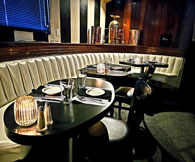 Curved booths: where comfort meets privacy. The leather seating whispers "stay awhile" while the wood paneling nods approvingly.