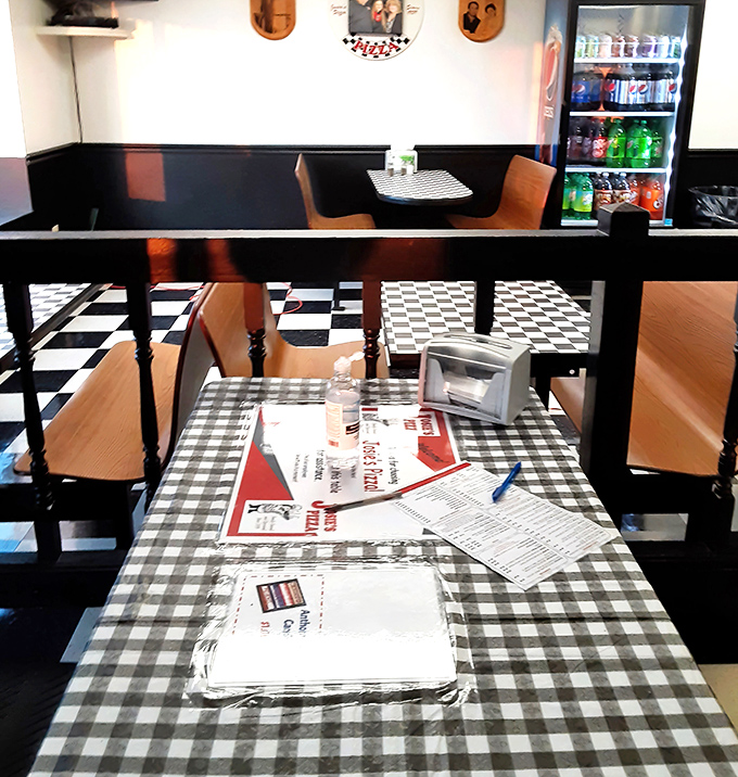Classic black and white checkered floors meet cozy booths&mdash;the timeless pizzeria aesthetic that instantly makes you feel like a regular.