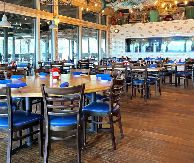 Blue chairs and wooden tables set the stage for seafood memories, while windows frame the coastal views like living paintings.