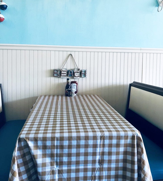 Checkered tablecloths and nautical wall decor create the perfect backdrop for seafood memories. This isn't just a table—it's where friendships deepen over shared scallops.
