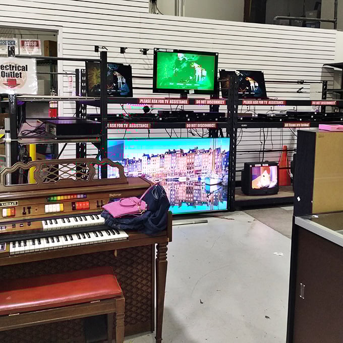 Electronic entertainment corner featuring TVs, a vintage organ, and enough gadgets to make any tech tinkerer's heart skip a beat. Remote control included!