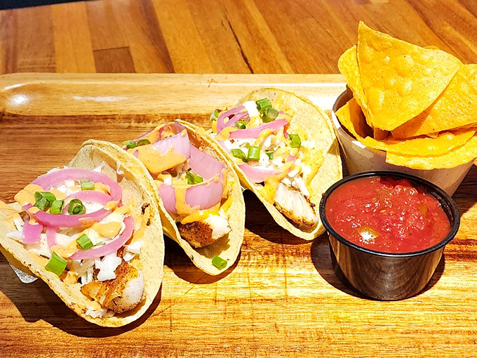 Fish tacos lined up like eager contestants in a beauty pageant, their fresh toppings and vibrant colors competing for your attention and affection.