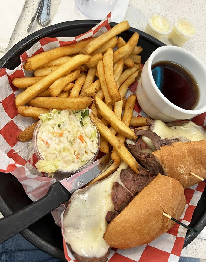 The French Dip sandwich arrives with enough fries to feed a small nation and au jus so good you'll consider drinking it like a soup when no one's looking.