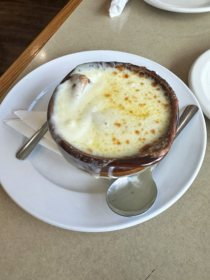 French onion soup with a cheese cap so perfectly browned and bubbly, it deserves its own slow-motion entrance music.
