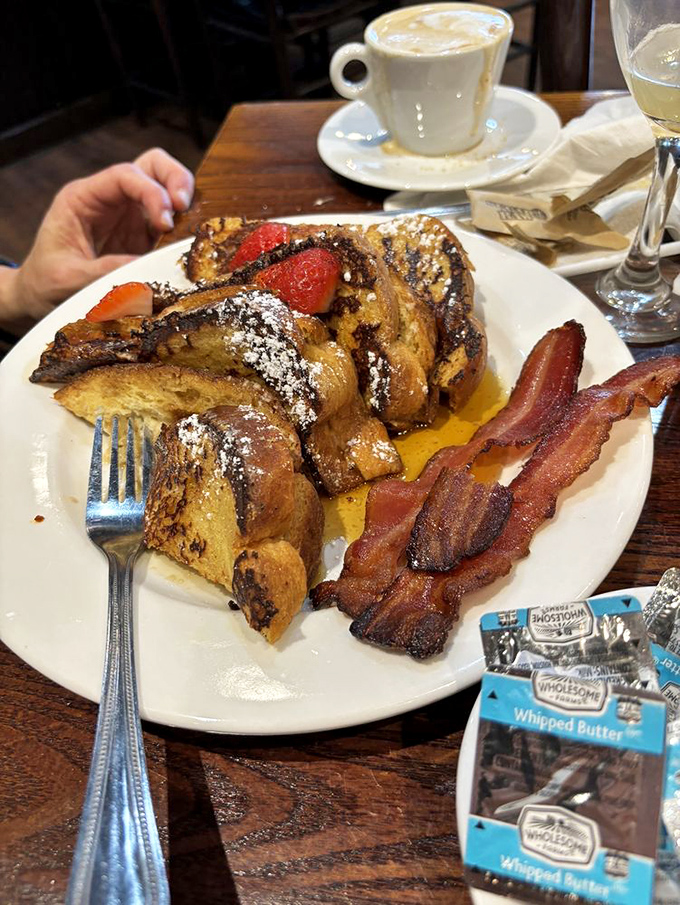 French toast that's clearly been living its best life, dressed up with strawberries and powdered sugar like it's heading to breakfast prom.