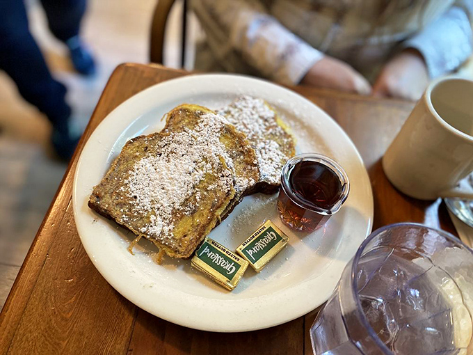 French toast dusted with powdered sugar like the first snow of winter. Two pats of butter standing by for their melting moment.