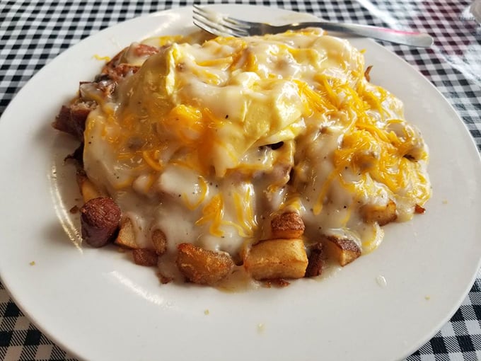 Comfort food architecture at its finest. Layers of potatoes, cheese, and savory goodness creating a breakfast skyline worth admiring.