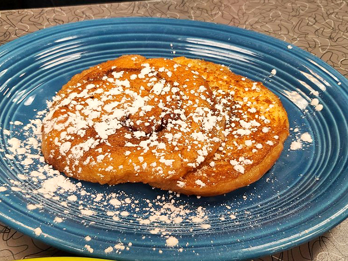 This isn't just a fried cinnamon roll—it's what happens when breakfast decides to live its best life. Powdered sugar snowfall included at no extra charge.