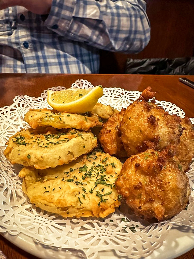 Fried green tomatoes and hush puppies on delicate doilies&mdash;Southern elegance that doesn't need white tablecloths to make you feel like royalty.