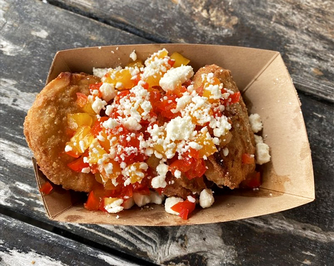 Fried perfection topped with fresh salsa and crumbled cheese. These golden discs prove that sometimes the simplest preparations create the most memorable bites.
