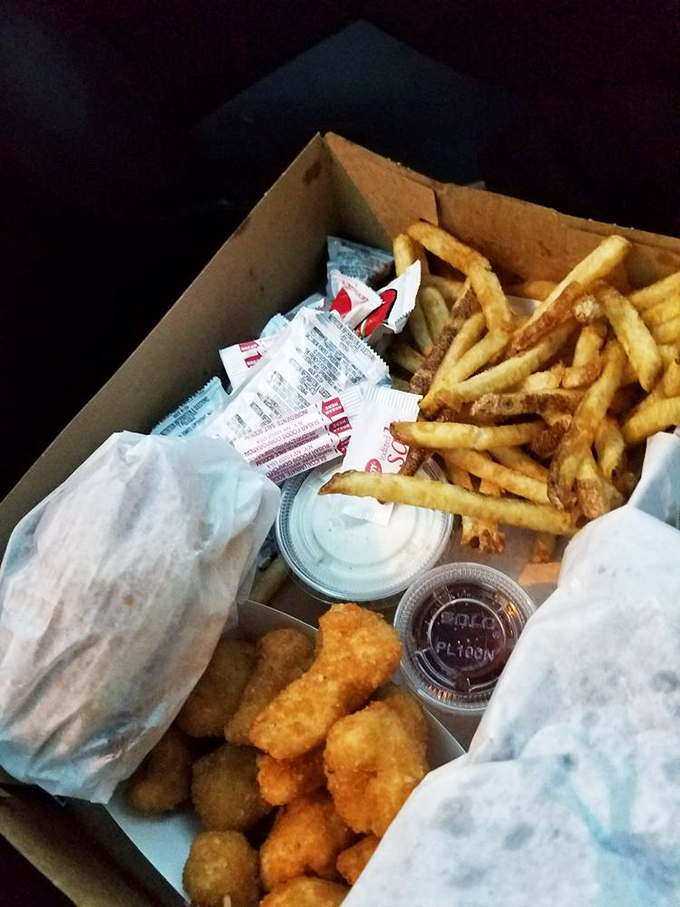 A to-go box filled with promises—crispy fries, nuggets, and the sauces that make life worth living after a long day.