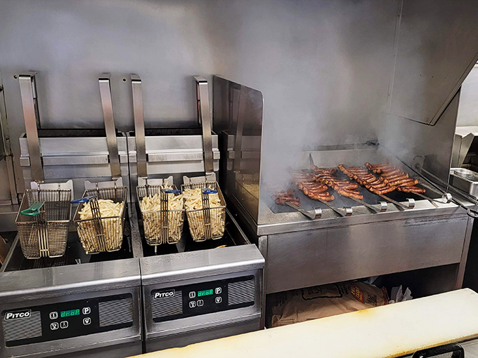 Where the magic happens&mdash;sausages sizzling on the grill while fries bubble in oil, a beautiful choreography of comfort food creation.