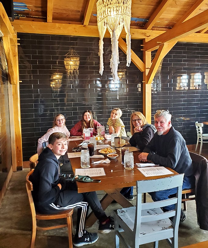 The dining room buzzes with happy conversation as families gather around mismatched chairs under those signature macram&eacute; chandeliers.