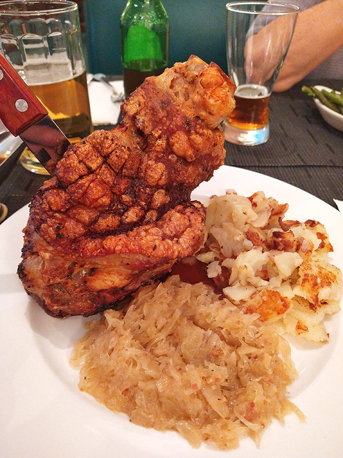 Crispy pork heaven sharing plate space with golden potatoes and tangy sauerkraut. This is what Germans mean by "the good life."