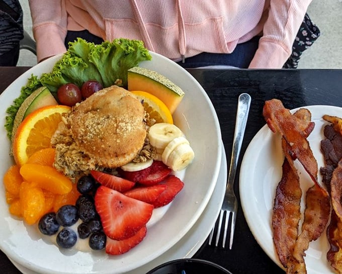 A symphony of fresh fruit surrounds what might be a muffin or granola creation—proof that healthy options can still look like celebration food.