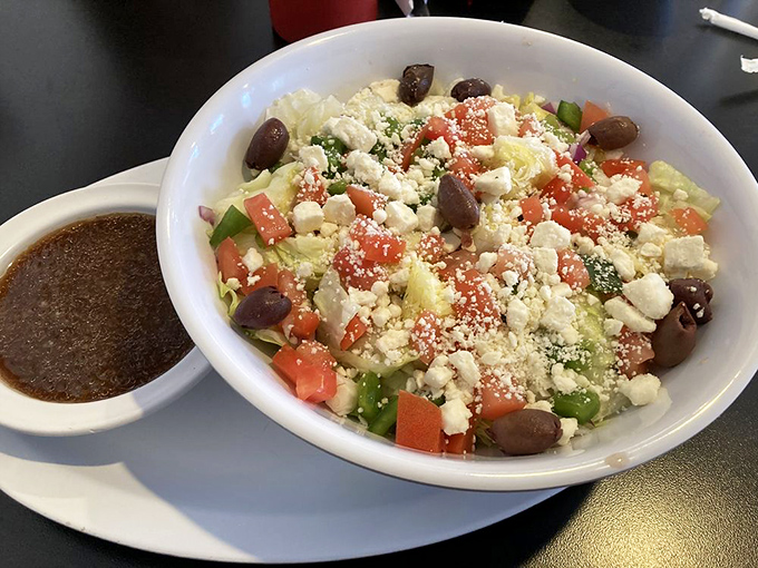 This Greek salad offers a refreshing counterpoint to diner indulgences &ndash; crisp vegetables, briny olives, and feta create Mediterranean vacation vibes.