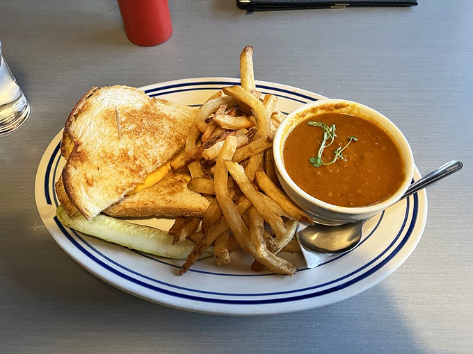 Grilled cheese and tomato soup: childhood comfort in adult portions. The golden-brown bread promises that perfect crisp-to-gooey texture ratio.