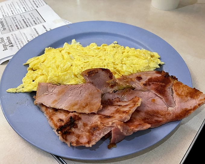 Simple perfection: fluffy scrambled eggs alongside ham that didn't come from a package with a sad expiration date.