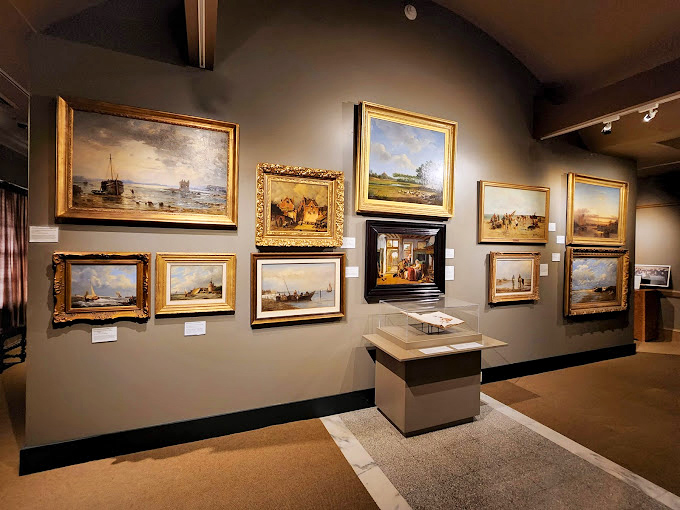 The Holland Museum's gallery wall showcases artistic treasures that transport visitors between two worlds—Michigan landscapes alongside Dutch masterpieces.