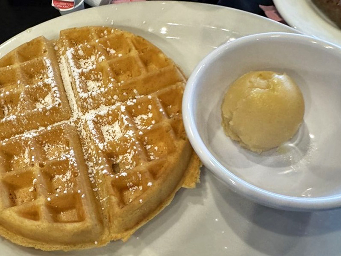 Simple perfection: a golden waffle with a scoop of butter slowly melting into those perfect grid valleys. Some art belongs in museums; some on plates. 