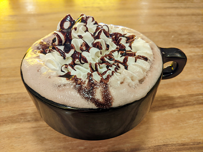 Hot chocolate that's dressed for a special occasion, with whipped cream and chocolate drizzle playing the roles of bow tie and cummerbund.