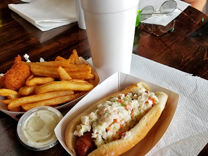 The hot dog comes dressed for success with a creamy slaw topping&mdash;proving that even the simplest pleasures deserve a touch of culinary respect.