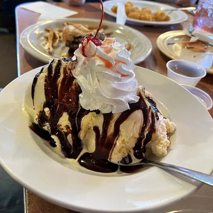 Ice cream architecture that deserves its own HGTV special. That hot fudge waterfall is creating property value with every delicious drip.