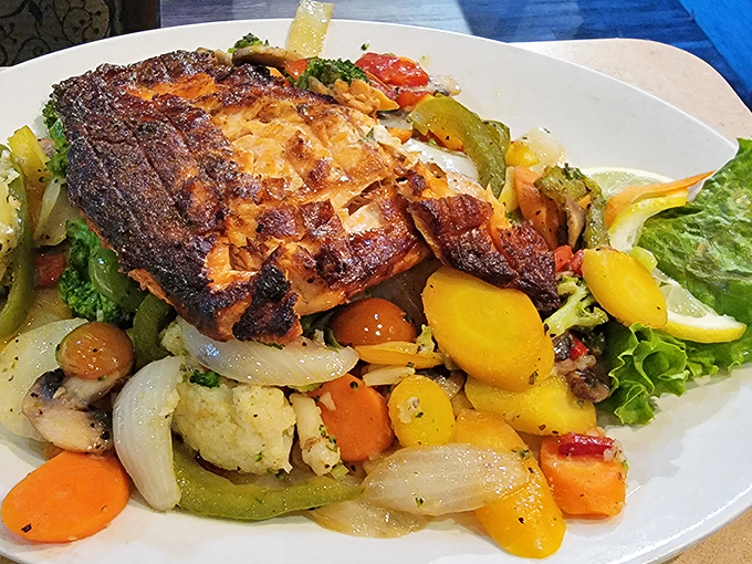 The salmon, perched atop a garden of vegetables, wears its char marks like medals of honor. A fish this good deserves a standing ovation.