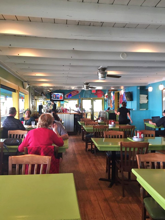 The bustling interior feels like a coastal living room where everyone's invited. Those lime-green tables aren't just furniture&mdash;they're conversation starters.