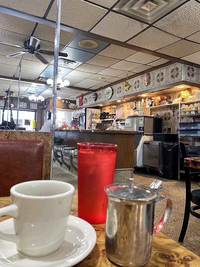 Coffee, cream, and conversation—the holy trinity of diner culture captured in one perfect frame of Sulimay's lived-in charm.