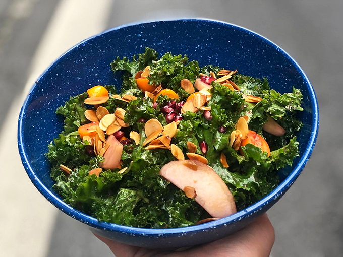 A kale salad that doesn't taste like punishment. With pomegranate seeds and apple slices, it's the dish you order to feel virtuous before demolishing a burger.