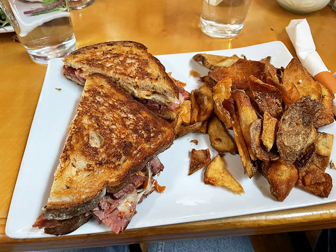 This sandwich isn't just lunch&mdash;it's architecture. Layers of savory goodness stacked between perfectly griddled bread with fries playing a supporting role.