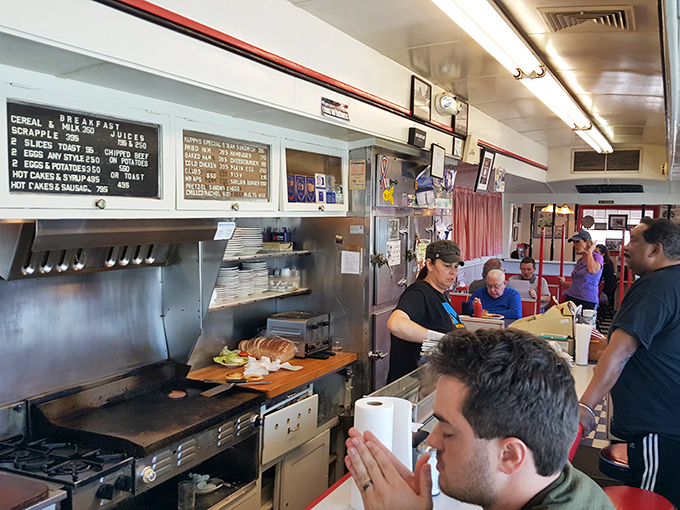 The best theater in town happens behind that counter, where breakfast choreography has been perfected over decades.