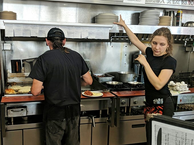 Where breakfast dreams come true&mdash;the open kitchen at Wynn's. No fancy techniques, just skilled hands creating morning masterpieces with practiced efficiency.