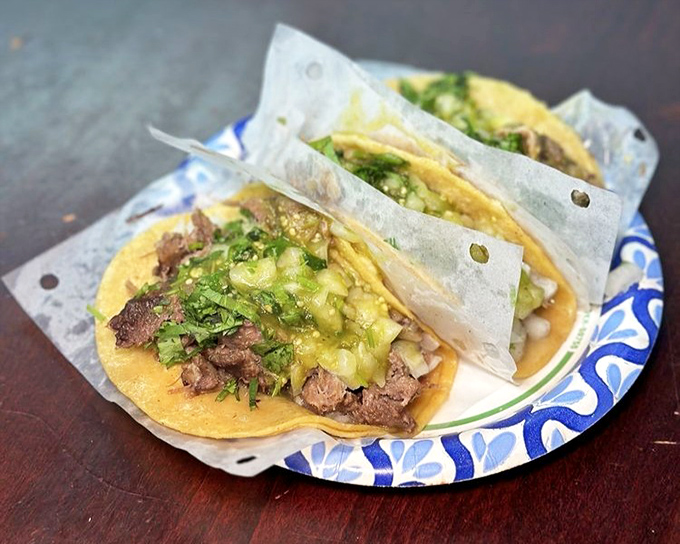 Lengua tacos topped with vibrant salsa verde &ndash; adventurous eating has never looked so inviting. 